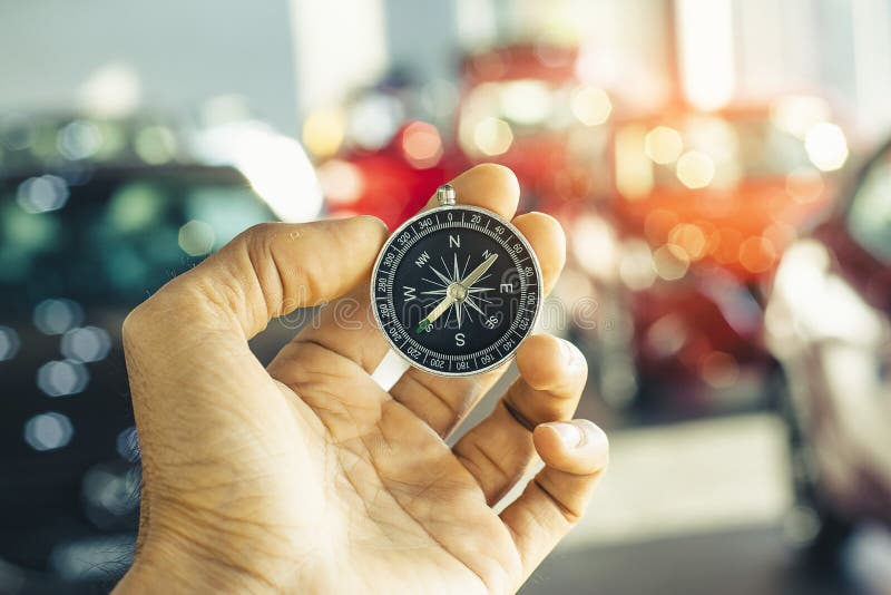 Holding Compass on Blurred Background. Using Wallpaper or ...