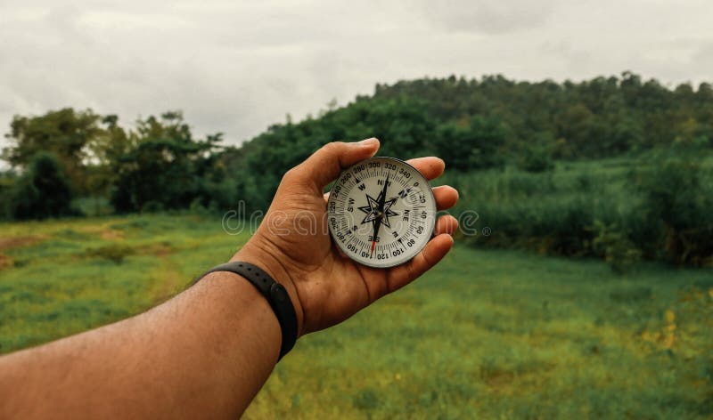 Holding compass in hand stock photo. Image of magnet - 166473776