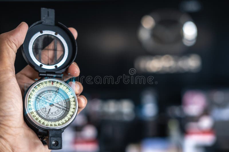 Holding Compass on Tree Mountain and Sea Blurry Background. Stock Image ...
