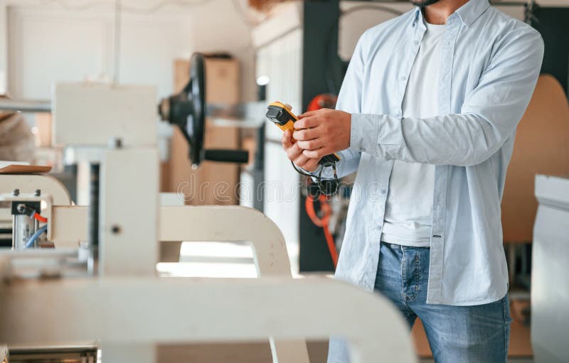 Holding Controller of Printing Machine. Polygraph Worker in White ...