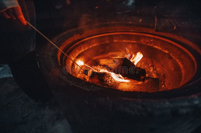 Holding Cooking Marshmallow Over Fire in Fireplace in Rovaniemi ...