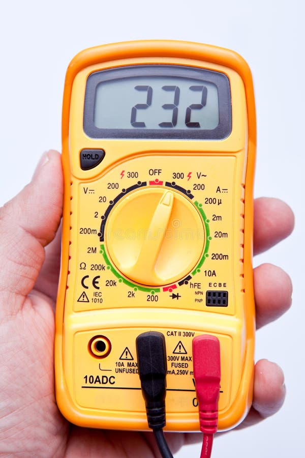 Holding digital multimeter stock image. Image of power - 31675429