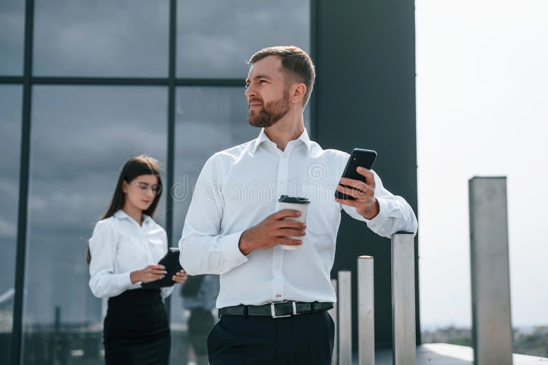 Holding Drink and Notepad. Man with Woman are Working on the ...