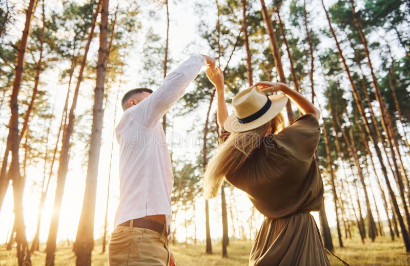 Holding Each Other by the Hands. Happy Couple is Outdoors in the Forest ...