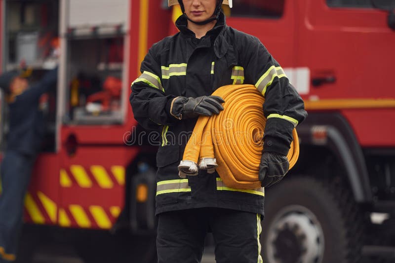 Holding Fire Hose. Woman in Uniform is at Work in Department Stock ...