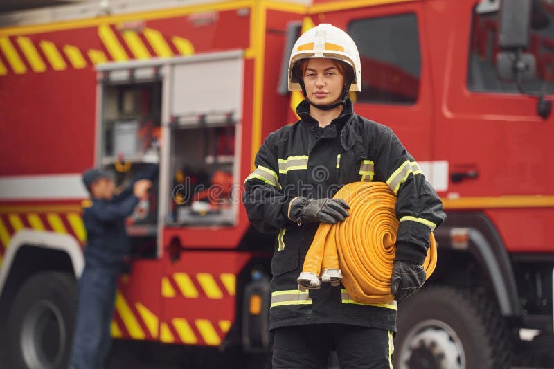 Holding Fire Hose. Woman in Uniform is at Work in Department Stock ...