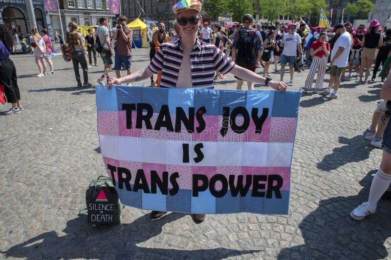 Holding a Flag with the Text Trans Joy is Trans Power at Pride Walk at ...