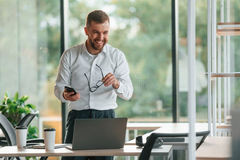 Holding Glasses and Smiling. Man in Formal Clothes is Working in the ...