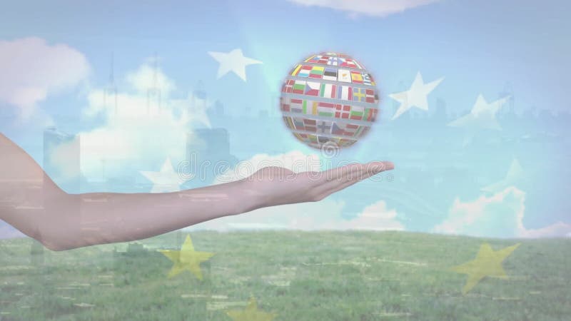 Holding Globe with International Flags, Hand Above Grassy Field and ...