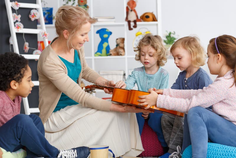 Holding the guitar stock image. Image of learning, group - 95304325