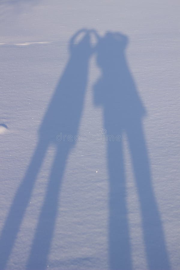 Holding Hands Creating a Shadow in the Snow Stock Photo - Image of ...
