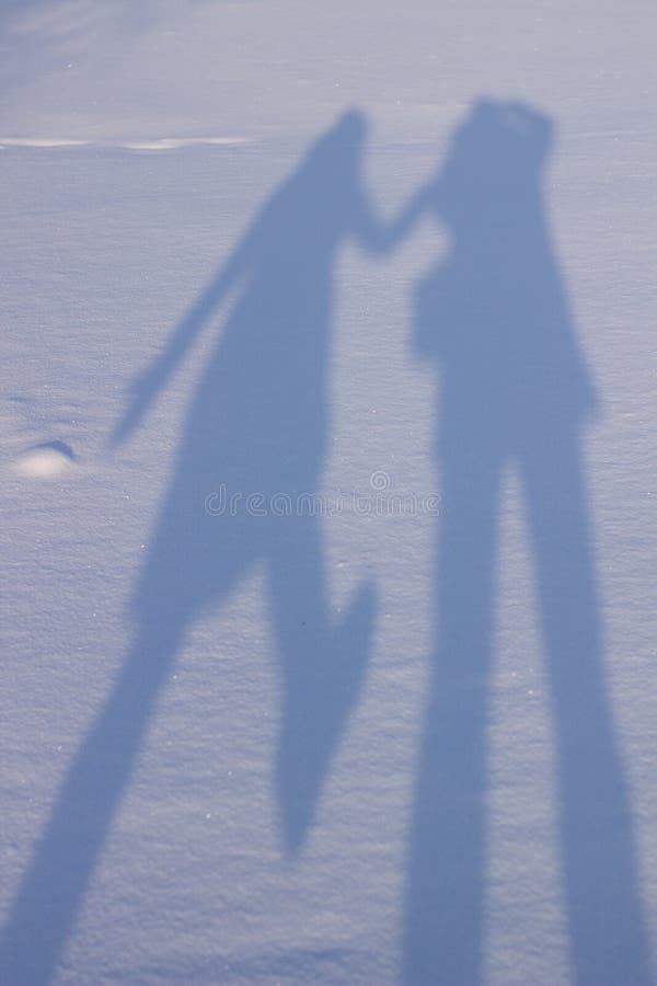 Holding Hands Creating a Shadow in the Snow Stock Photo - Image of ...