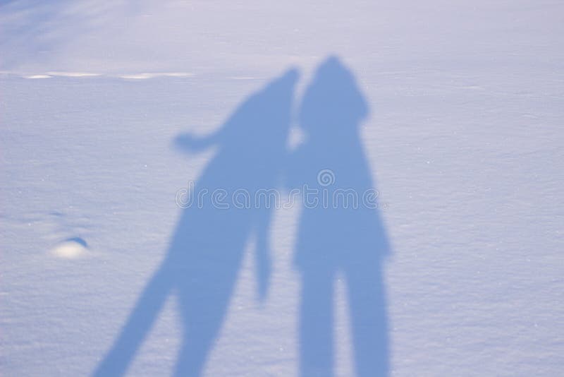 Holding Hands Creating a Shadow in the Snow Stock Photo - Image of ...