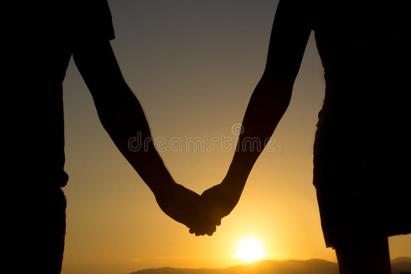 Holding Hands in Front of Sunset Stock Image - Image of hands, colors ...
