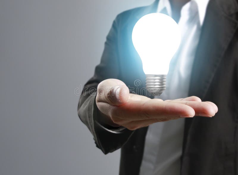 Holding light bulb in hand stock illustration. Illustration of ...