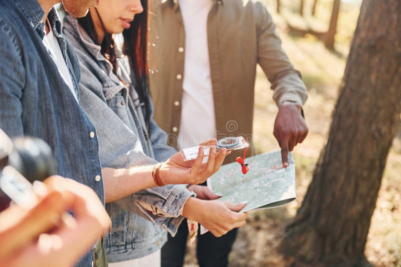 Holding Map and Looking for Location. Group of Young People is ...