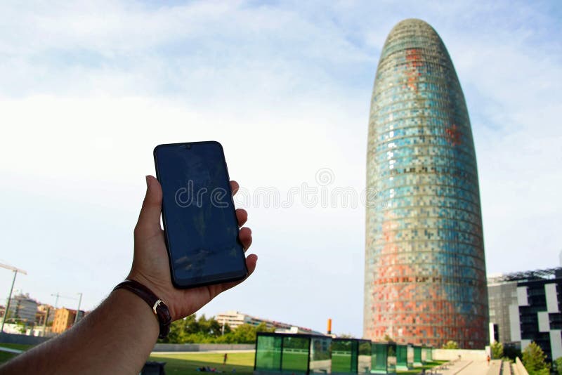 Holding a Mobile Phone in Front of a Modern Building. Stock Photo ...