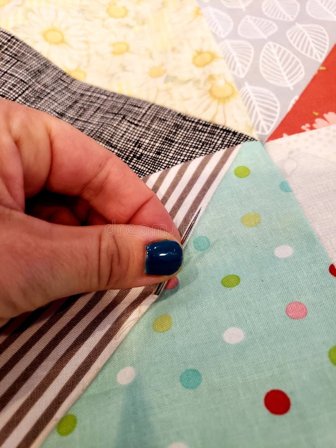 Holding a Needle and Thread on Colorful Quilting Triangles Stock Photo ...