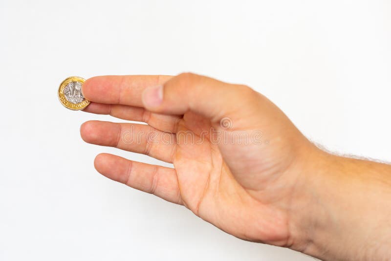 Holding one pound in hand stock image. Image of europe - 158511719