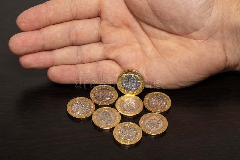 Holding one pound in hand editorial photography. Image of kingdom ...