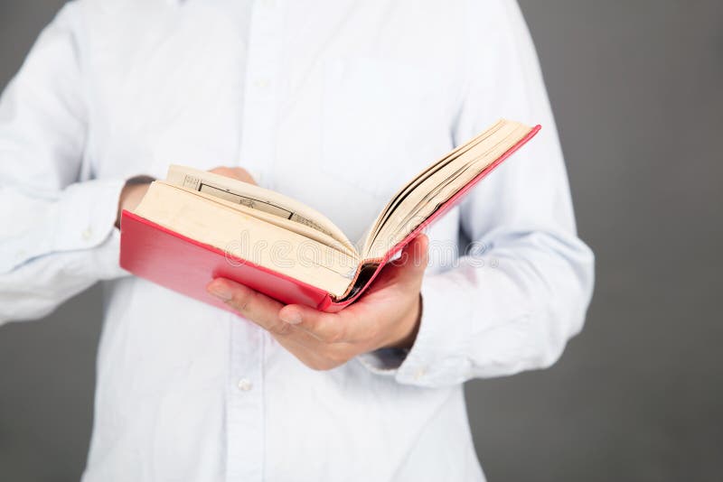 Holding open books in hand stock image. Image of close - 253701387
