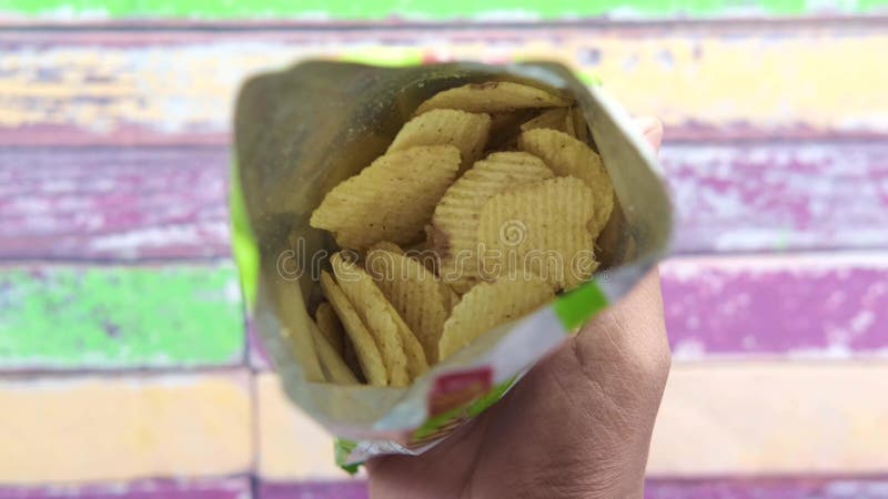 Holding a Open Potato Chips Packet Top View Stock Footage - Video of ...