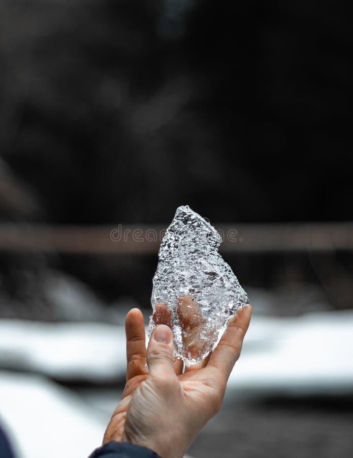 Holding a piece of ice stock image. Image of landscape - 146177541