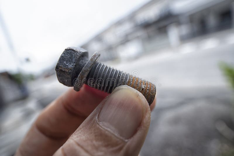 Holding a Piece of Rusted Bolt Nut in the Finger. Stock Photo - Image ...