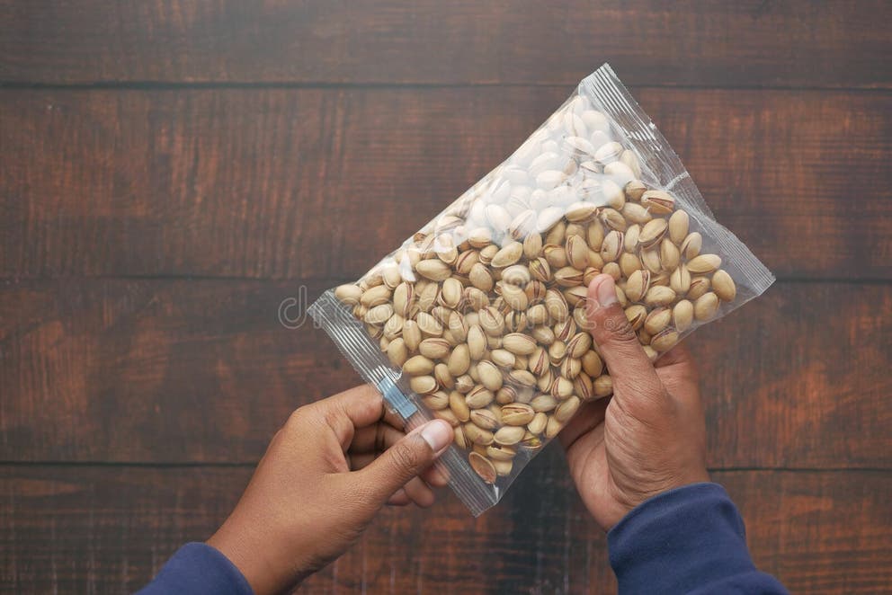 Holding a Pistachios Nut Plastic Packet Stock Photo - Image of nutshell ...