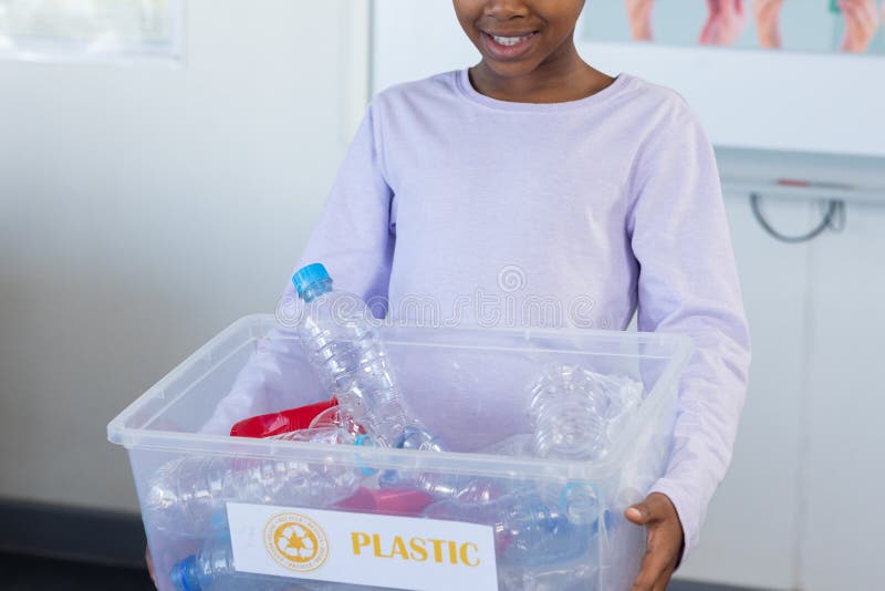 Holding Plastic Recycling Bin, Student Smiling in Classroom at School ...