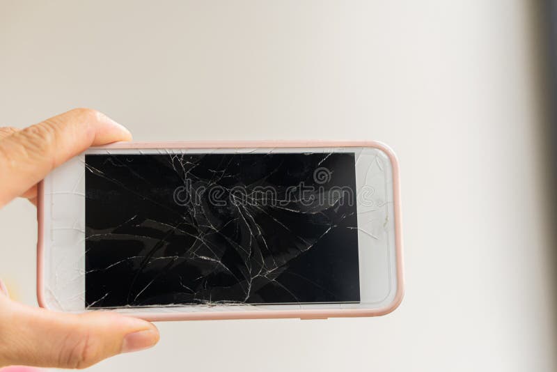 Holding a Smartphone with a Broken Screen and a Broken and Scratched ...
