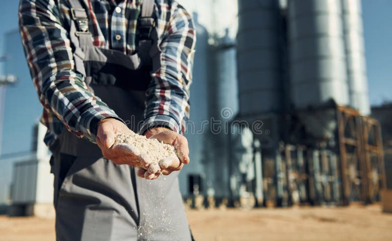 Holding Soil. Construction Worker in Uniform is Outdoors Near the ...
