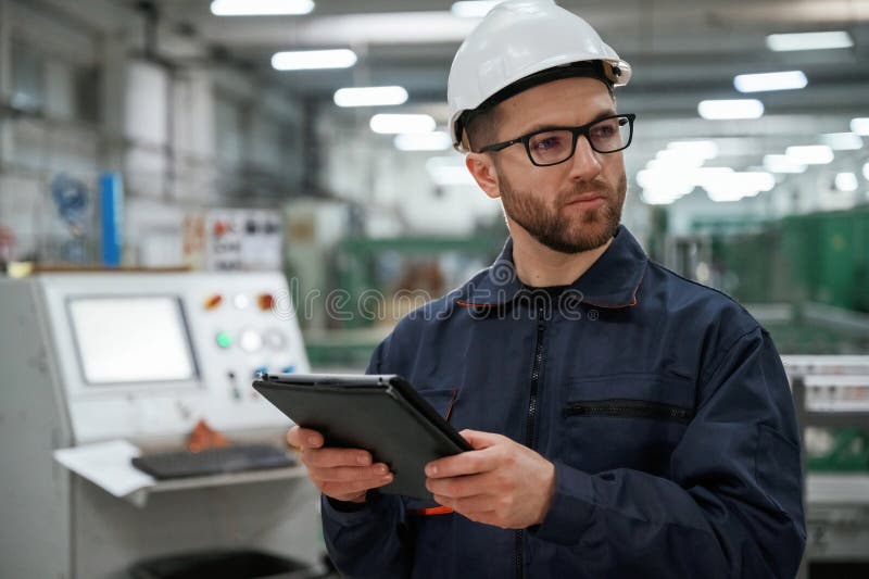 Holding Tablet. Factory Worker is Indoors with Hard Hat Stock Image ...