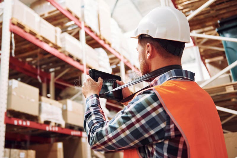 Employee in Uniform is Working in the Storage at Daytime Stock Photo ...