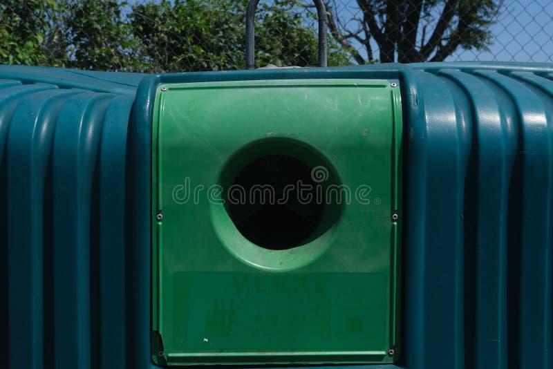 Hole of a Blue and Green Trash Container in Front of a Wire Fence Stock ...
