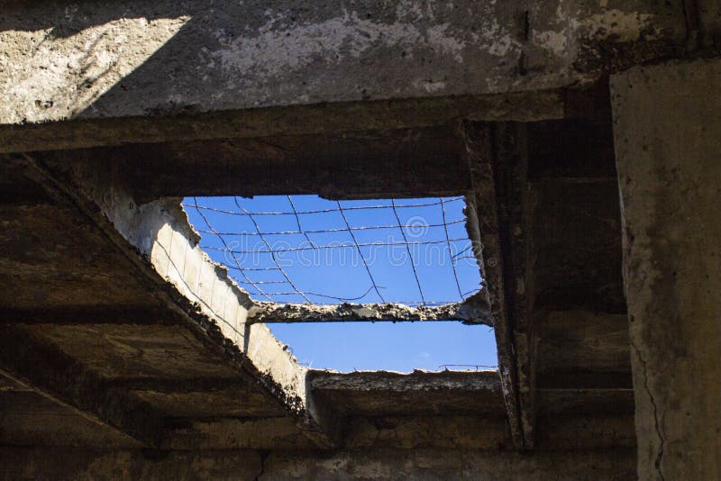 Hole in the Concrete Slab in Need of Repair, the Sky through the Bars ...