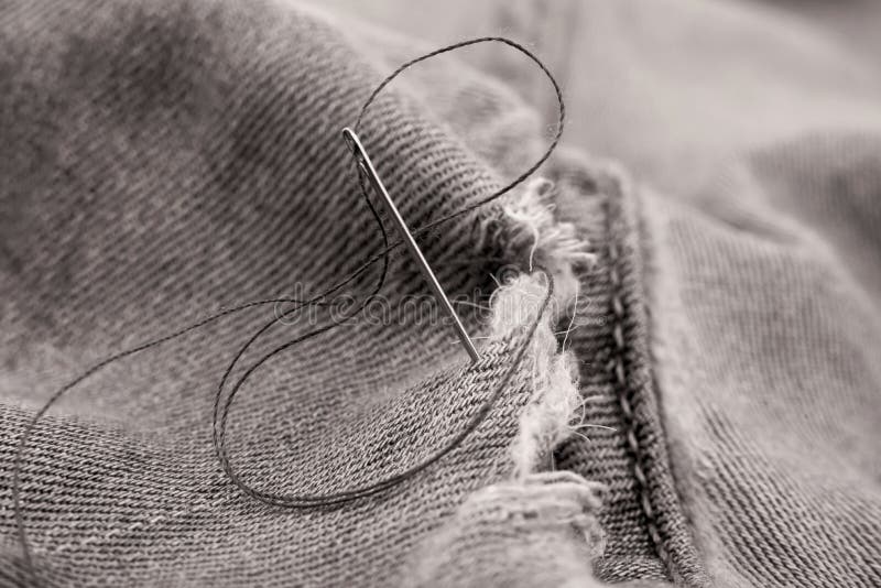 Hole in Jeans. Needle with Thread for Darning Jeans Stock Photo - Image ...