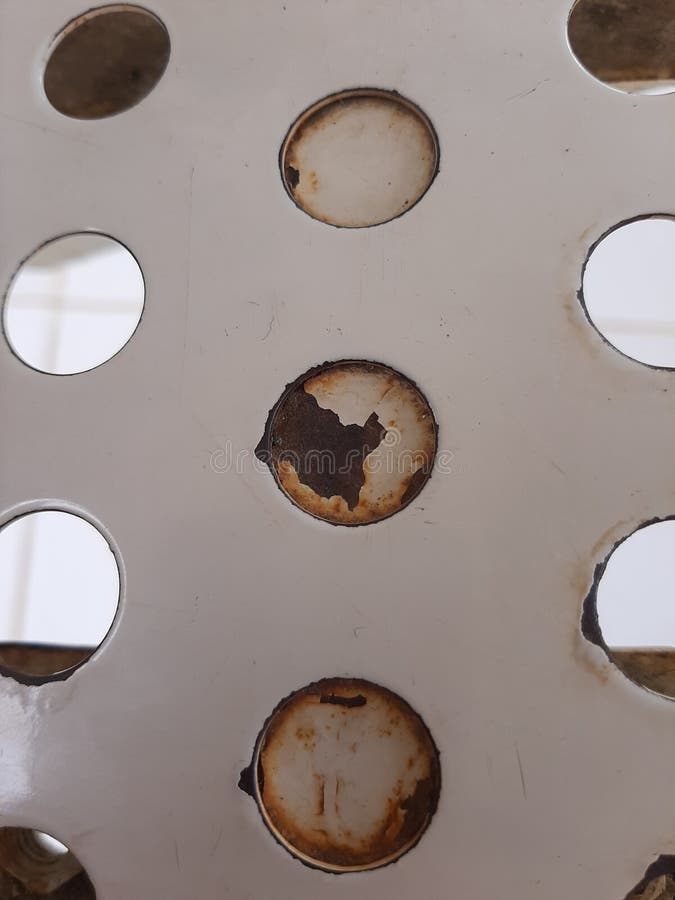 A Hole in an Old Iron that is Neatly Arranged in a Round Shape that ...