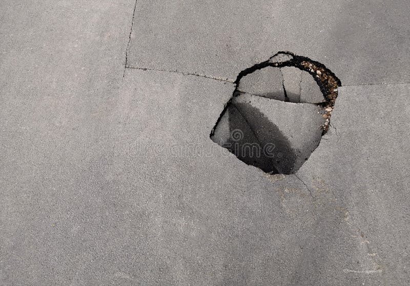 A Hole in the Road. Hole in the Asphalt. Broken Road Stock Photo ...