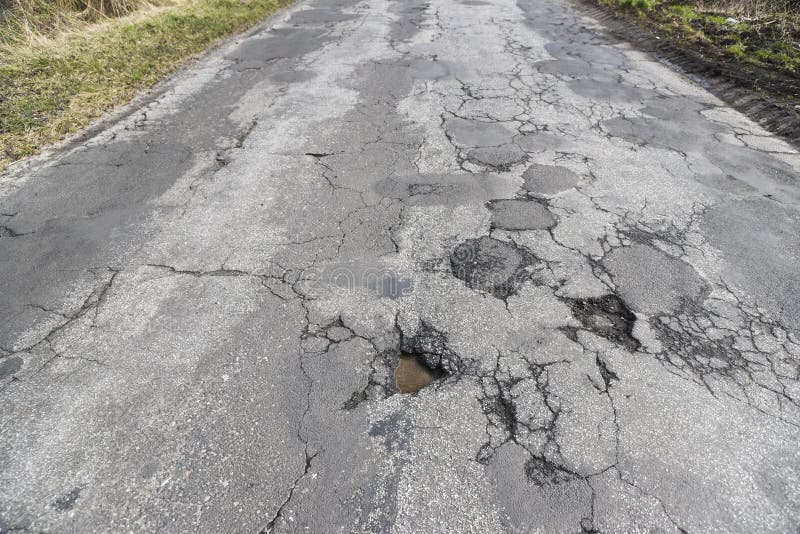Hole in the Road on a Damaged Asphalt Surface Stock Photo - Image of ...
