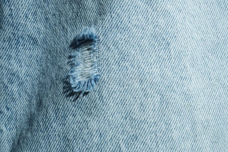 Hole and Threads on Denim Jeans. Ripped Destroyed Torn Blue Jeans ...
