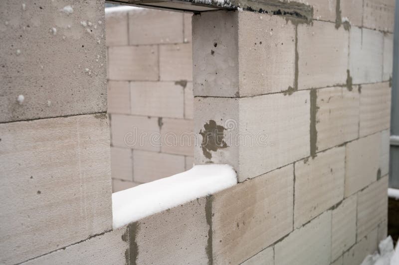 A Hole in the Wall of Aerated Concrete Bricks for a Square Window. Snow ...
