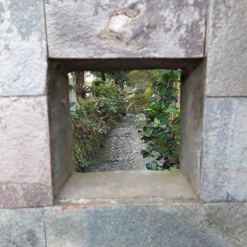 A Hole in the Wall of the Bridge Over the River Stock Photo - Image of ...