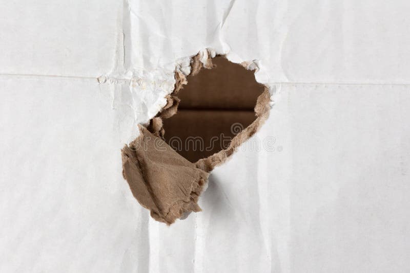 Hole in the Wall of a Cardboard Box Stock Photo - Image of advertising ...