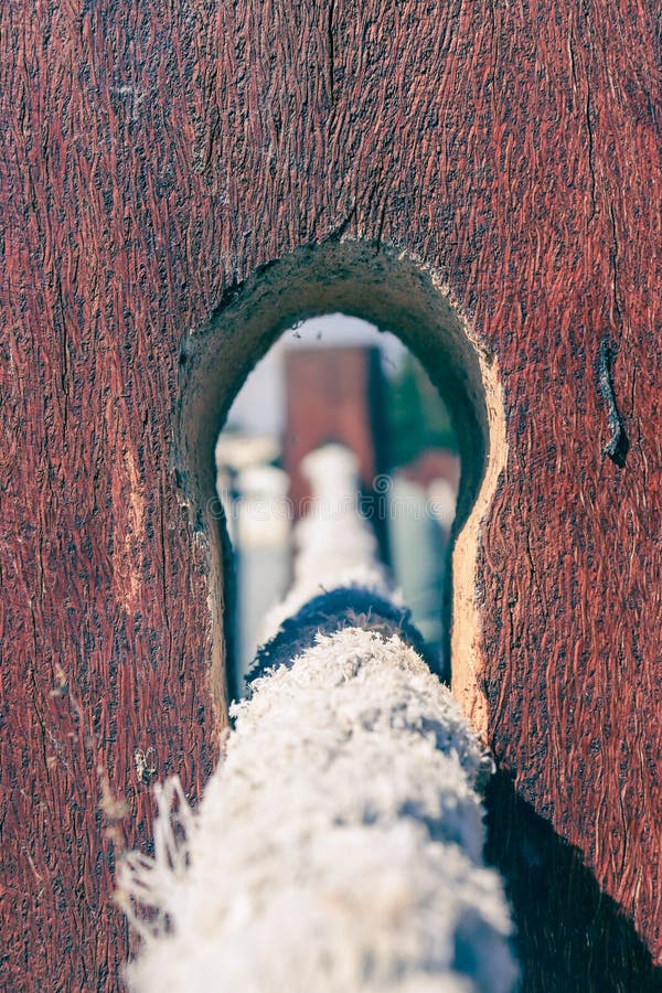 Hole in a wharf with rope stock photo. Image of water - 245598754