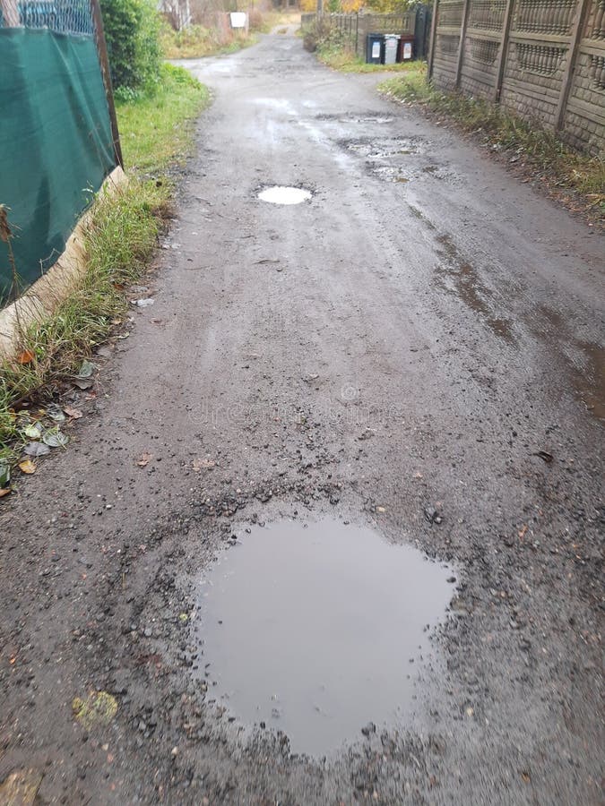 Holey non-asphalt road stock photo. Image of floor, sidewalk - 296578662