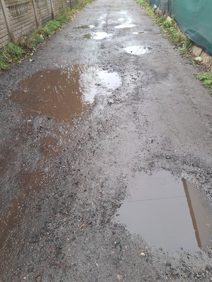 Holey non-asphalt road stock image. Image of waterway - 296578863