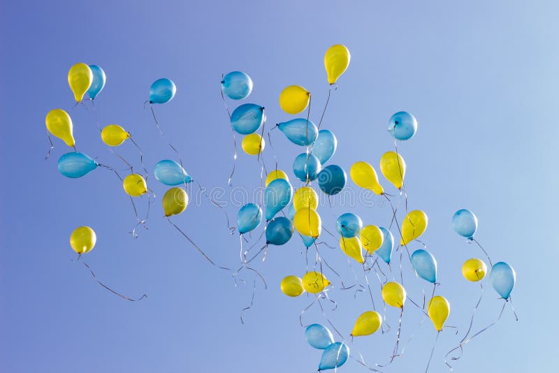 Holiday Blue and Yellow Flying Balloons in the Blue Sky Stock Image ...