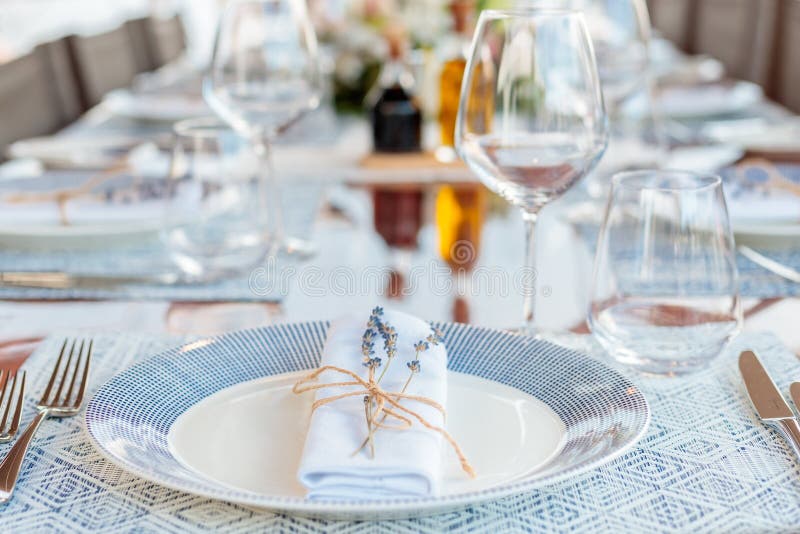 Holiday Table Setting with White and Blue Plates, Folded Napkins and ...