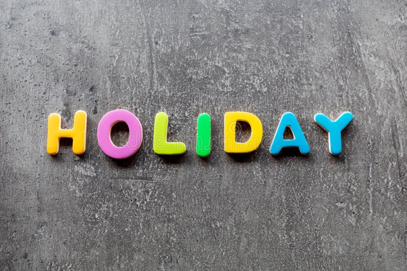 Holiday Word Written with Colorful Letters on Granite Stone Background ...